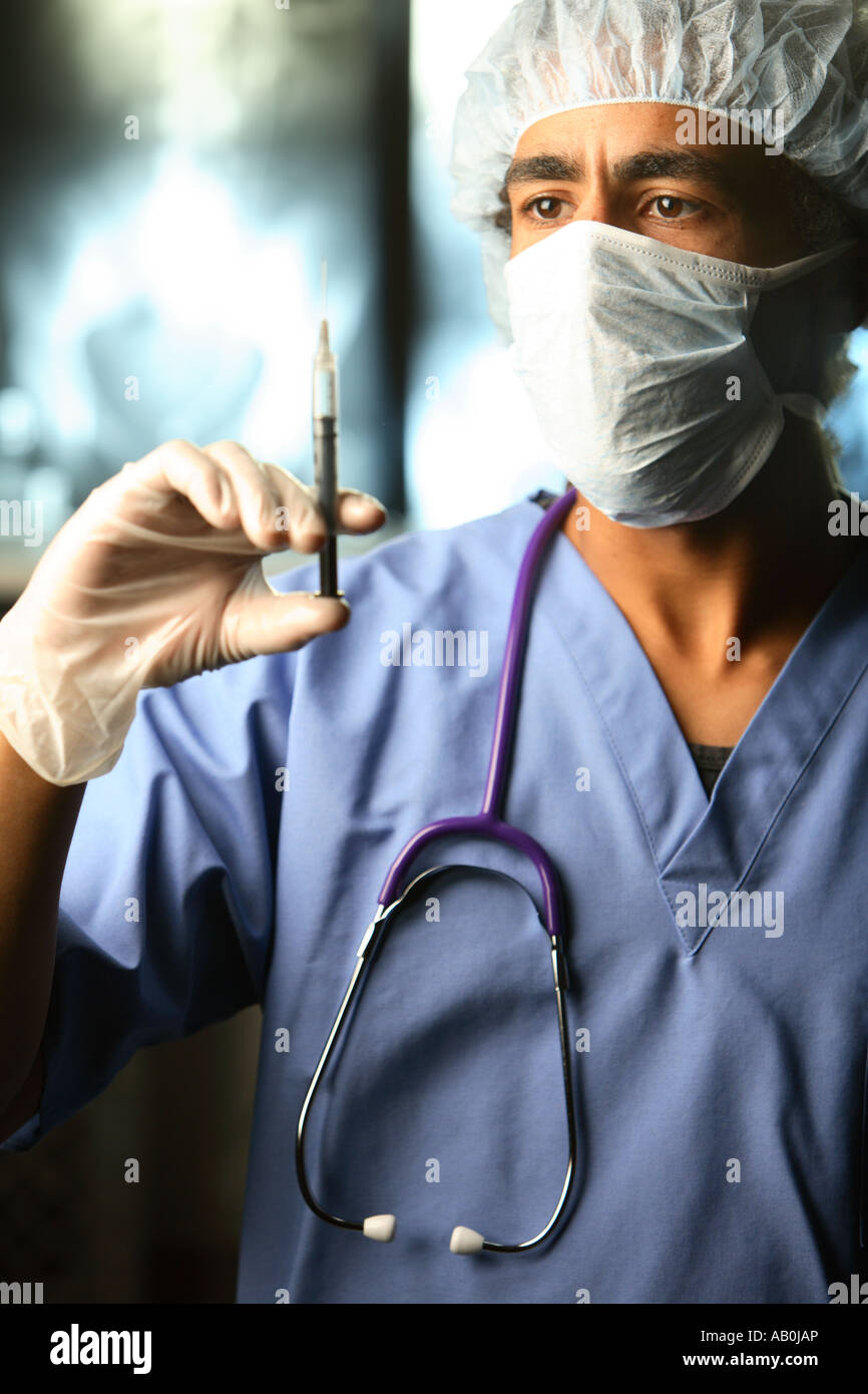 Doctor with syringe in hand Stock Photo - Alamy