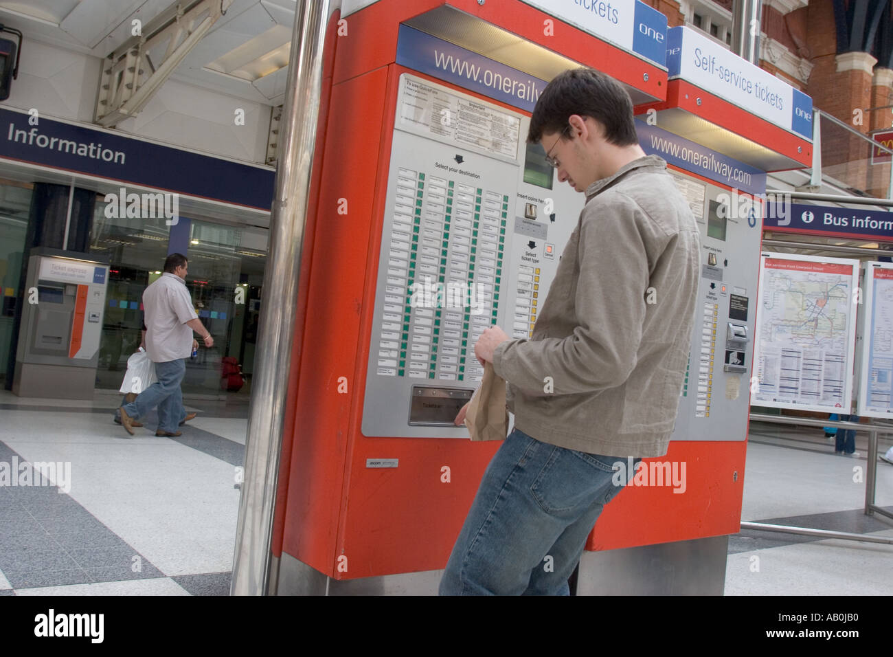 Passenger at ticket machine, Liverpool Street Station City of London GB ...