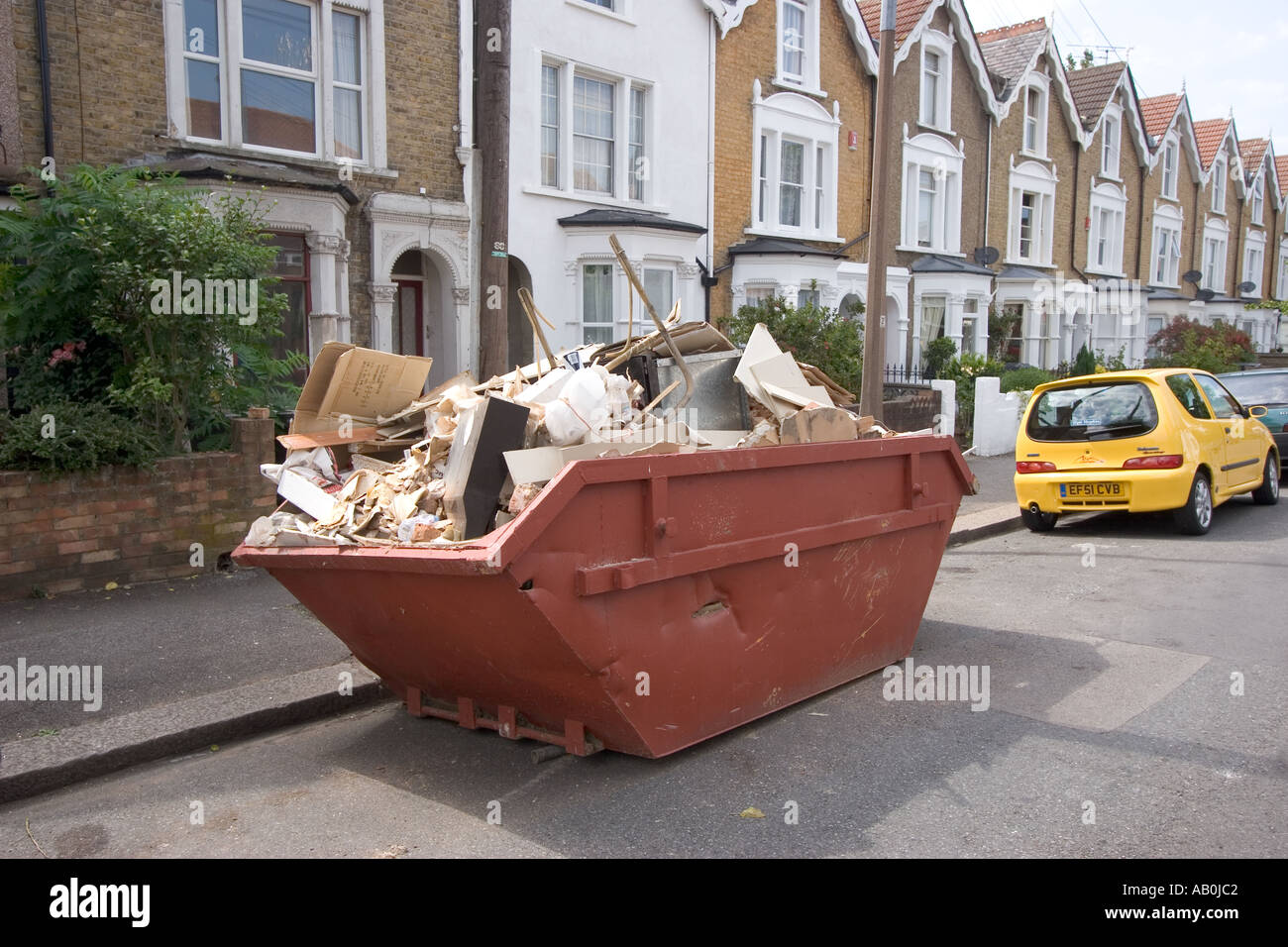 Skip in road and Front garden full of rubbish outside private ...