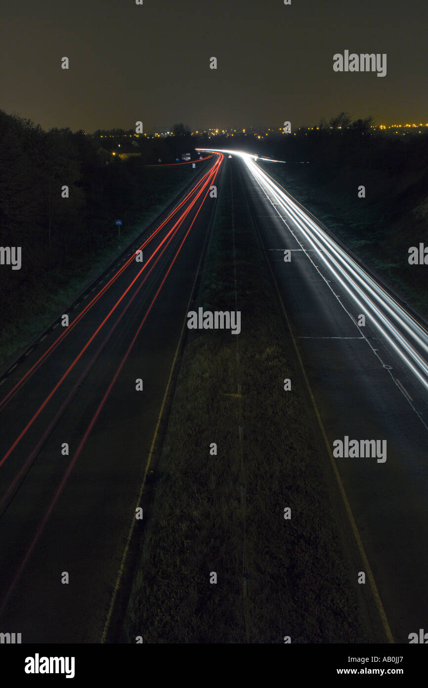 road at night time showing car lights going by Stock Photo - Alamy