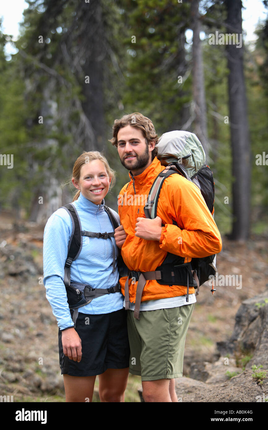 Portrait of couple backpacking Stock Photo - Alamy