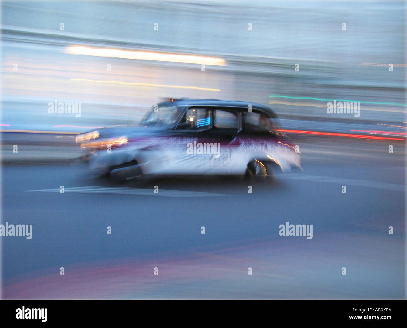 london taxi at speed at dusk Stock Photo - Alamy