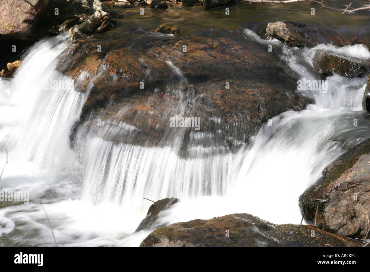Stream with rocks and flowing water in a broad fan shape across the ...