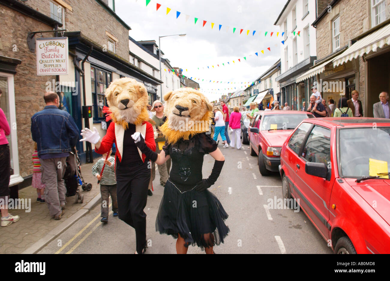 Performers from Giffords Circus in lion costumes parade on street as ...