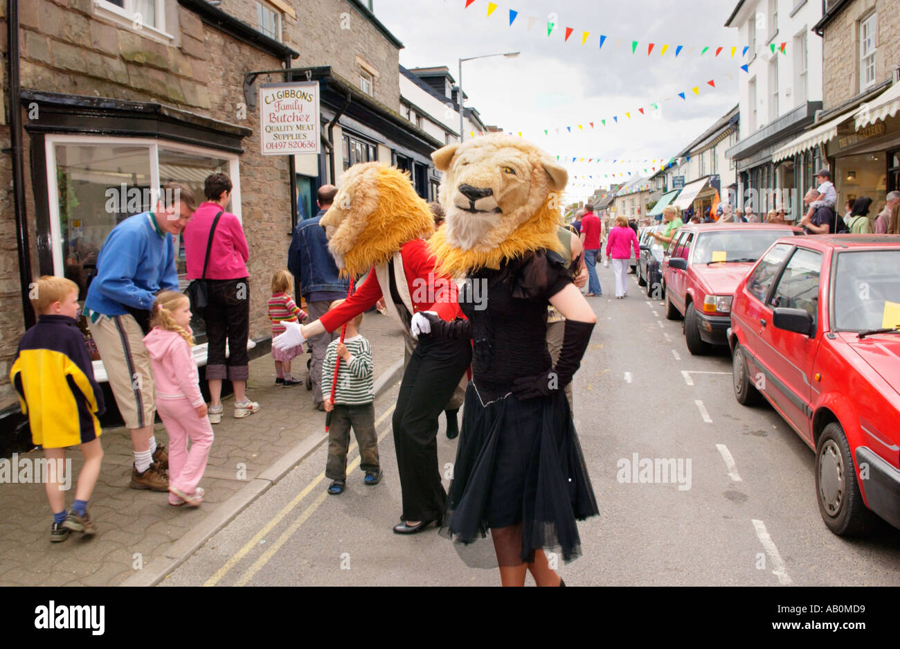 Performers from Giffords Circus in lion costumes parade on street as ...