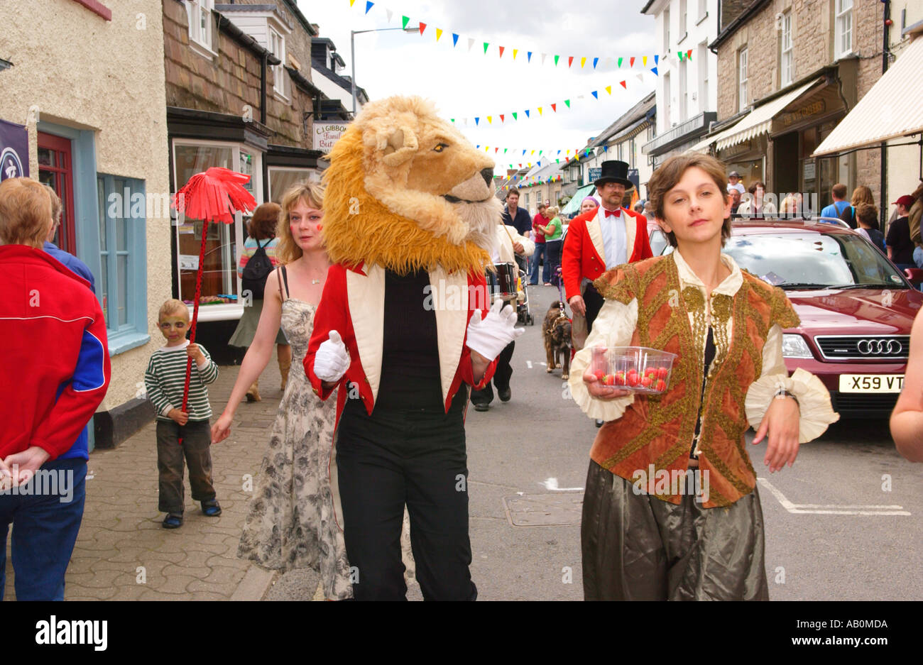 Performers from Giffords Circus in lion costumes parade on street as ...