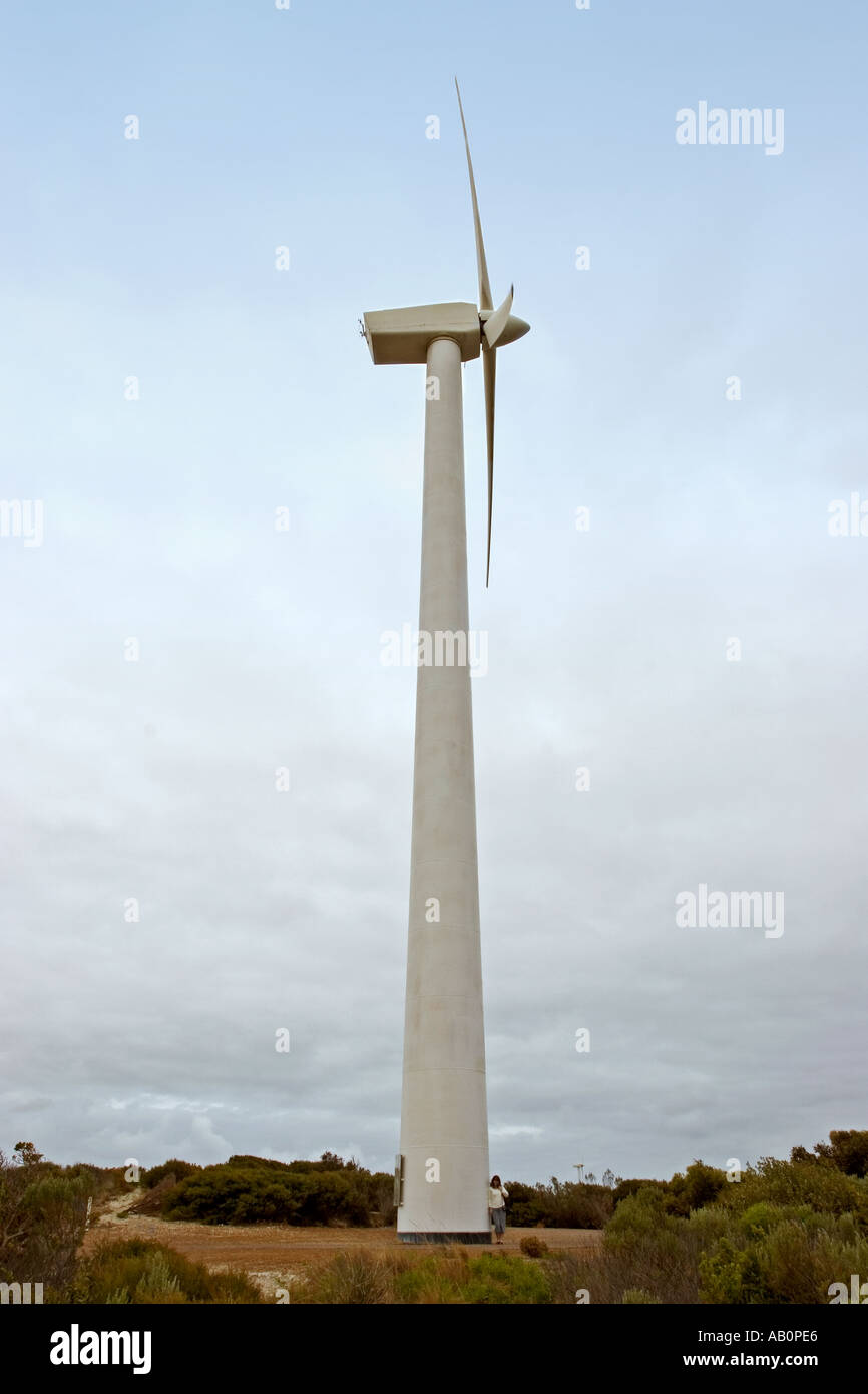 A wind turbine with person standing next to it to show how big they are ...