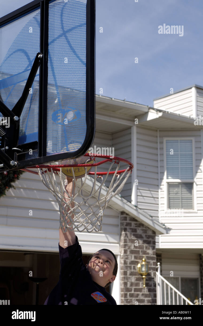 Front view of boy dunking basketball Stock Photo - Alamy