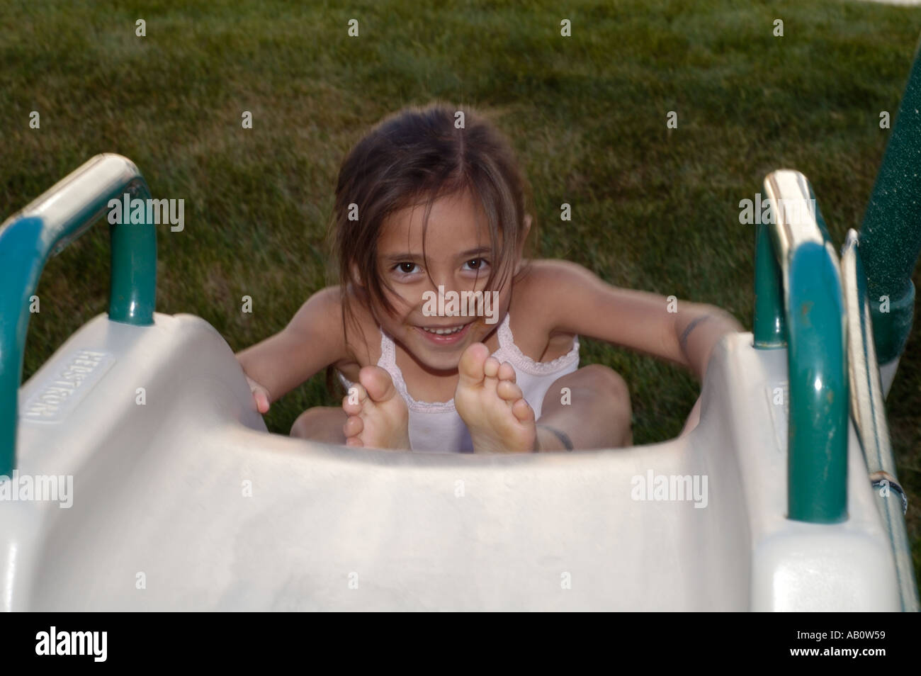 Girl climbing up slide hi-res stock photography and images - Alamy