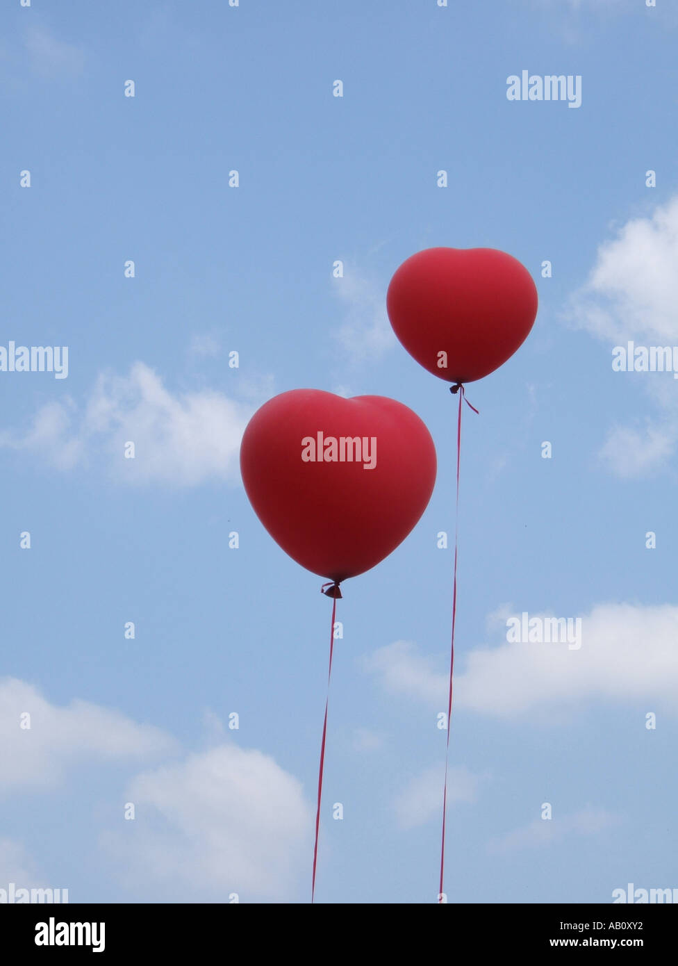 two heart shaped red balloons in blue sky Stock Photo - Alamy