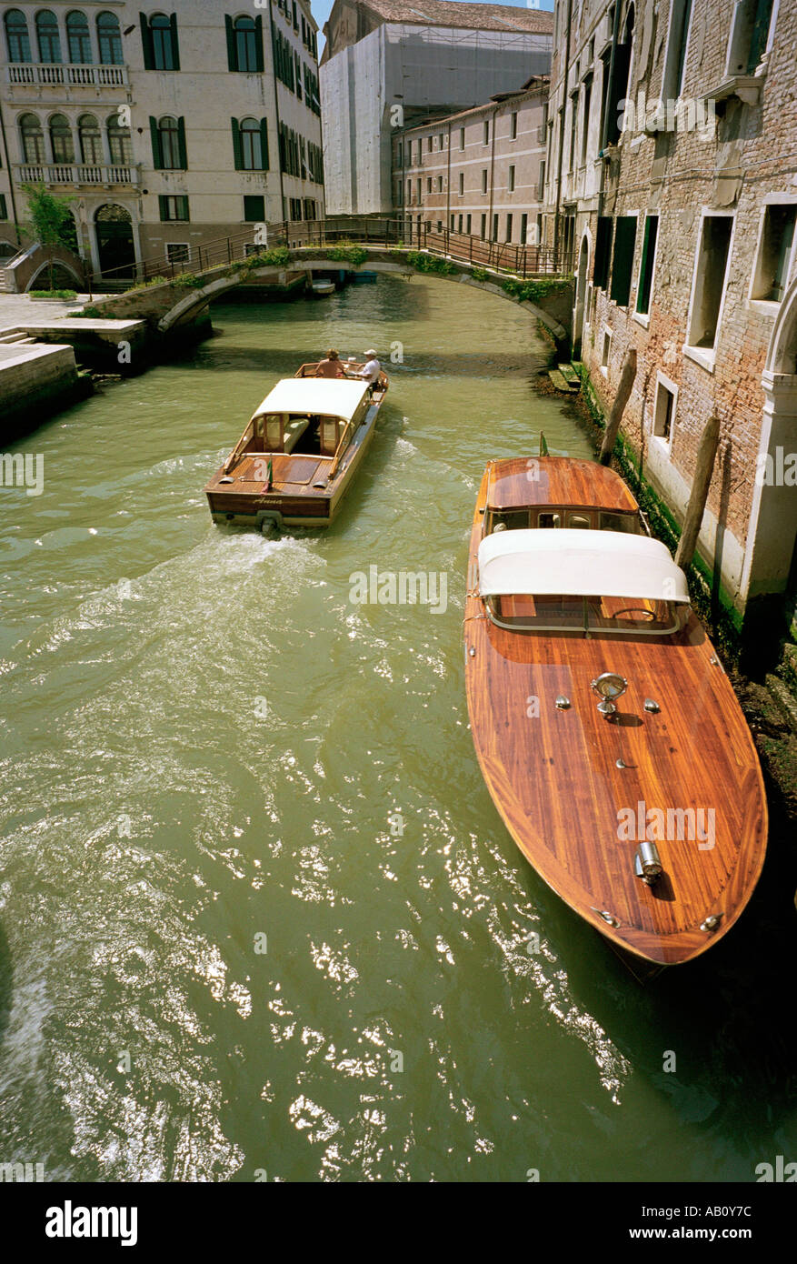 A typical scene in Venice with boats bridges ancient buildings and ...