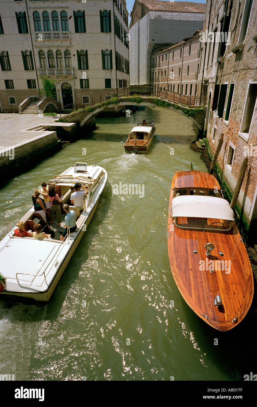 A typical scene in Venice with boats bridges ancient buildings and ...