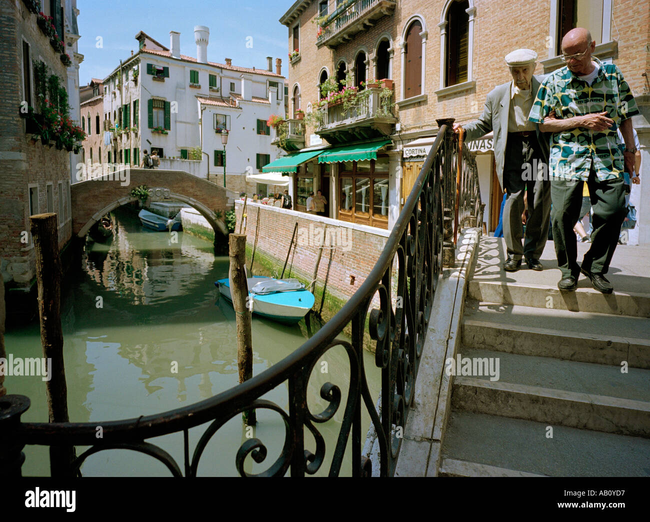 A typical scene in Venice with boats bridges ancient buildings and ...