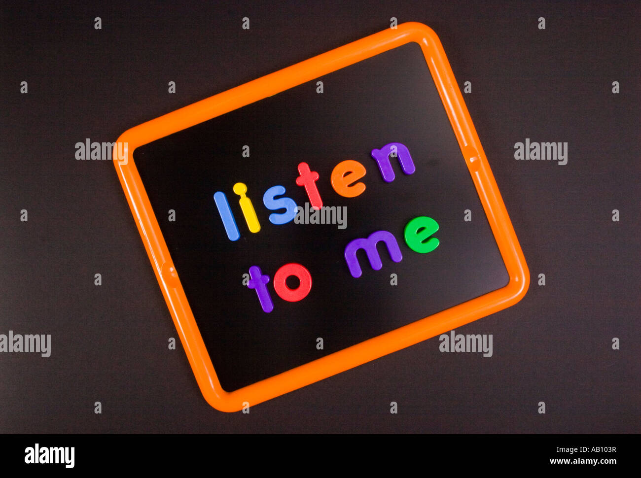 "Listen to Me", written with colourful plastic letters on a blackboard ...