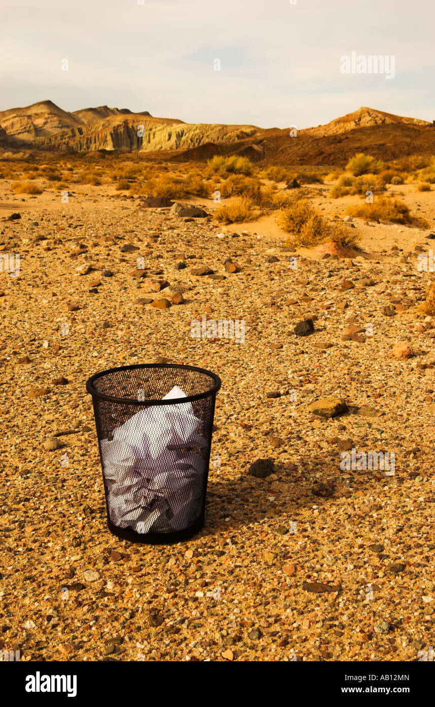 Household or office trash bin full of paper in a treeless desert. Shot ...