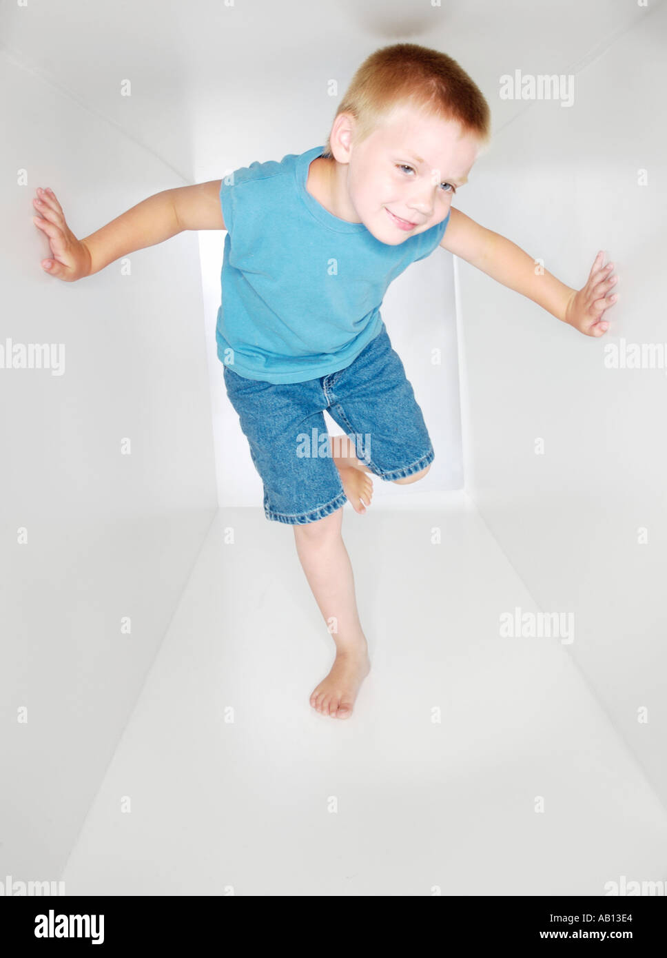 Boy playing inside box Stock Photo - Alamy