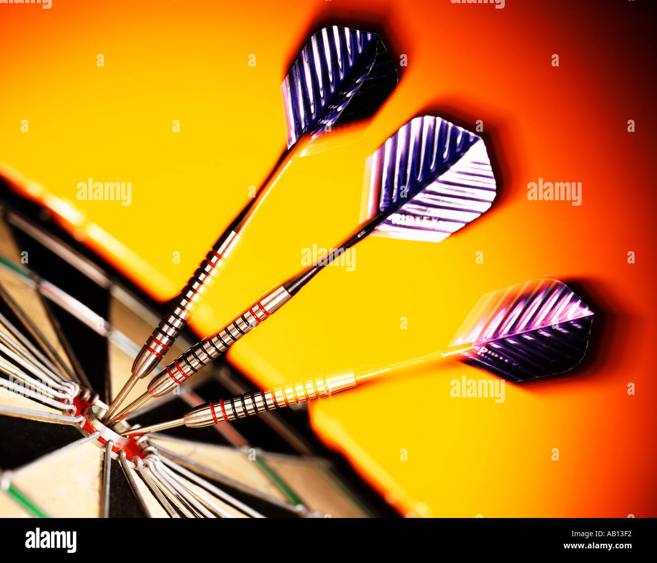 darts stuck in dartboard orange background Stock Photo - Alamy darts stuck in dartboard orange background Stock Photo - Alamy