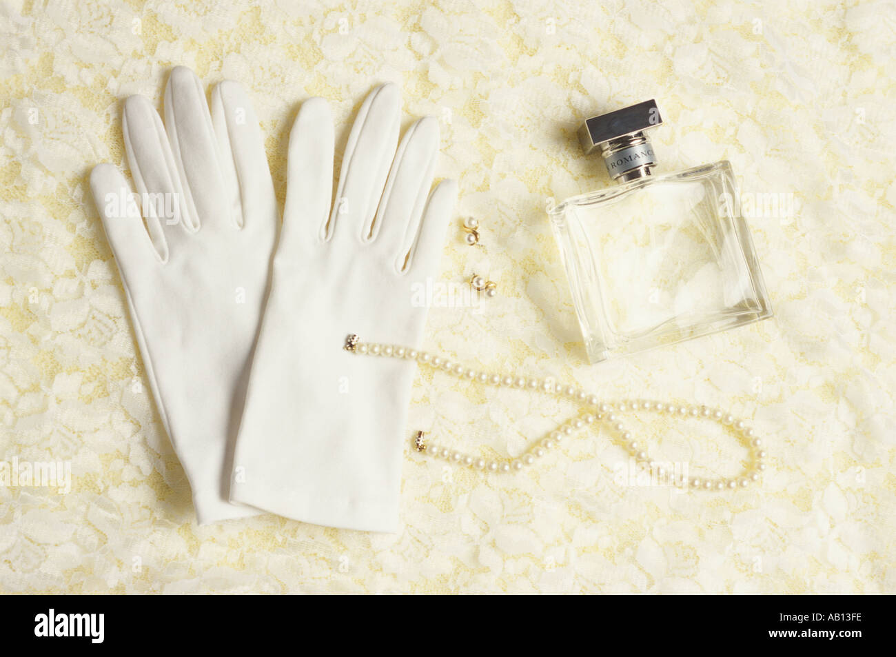 Gloves pearl necklace and perfume bottle Stock Photo - Alamy