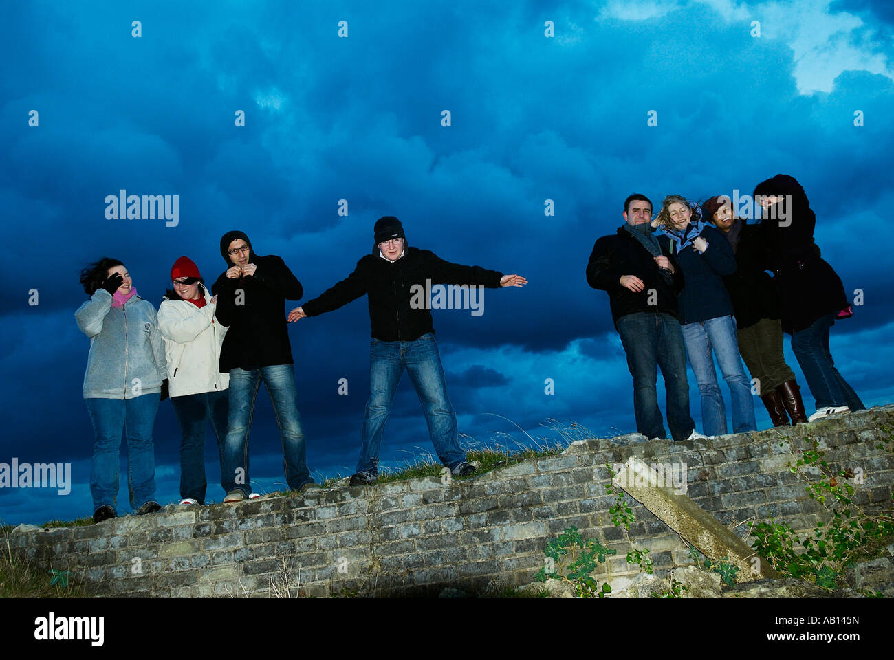 8 young people battle wind and rain Stock Photo - Alamy