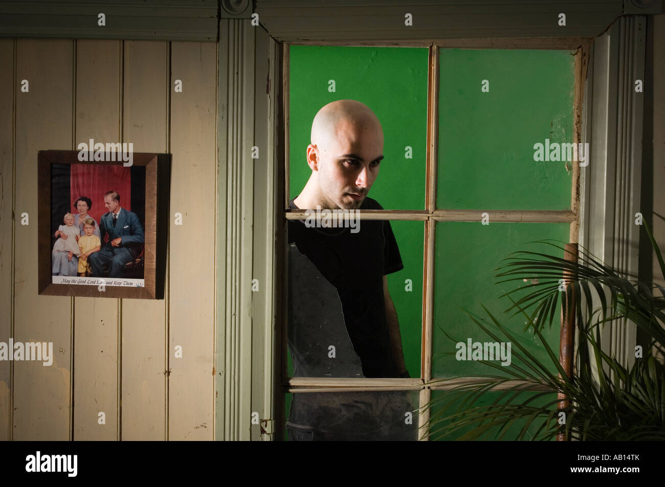 Sinister character in window, illuminated by harsh lighting Stock Photo ...