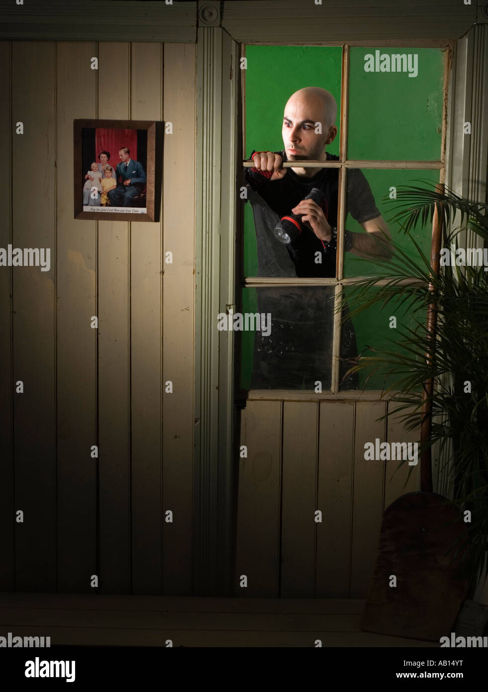 Sinister character in window, illuminated by harsh lighting Stock Photo ...