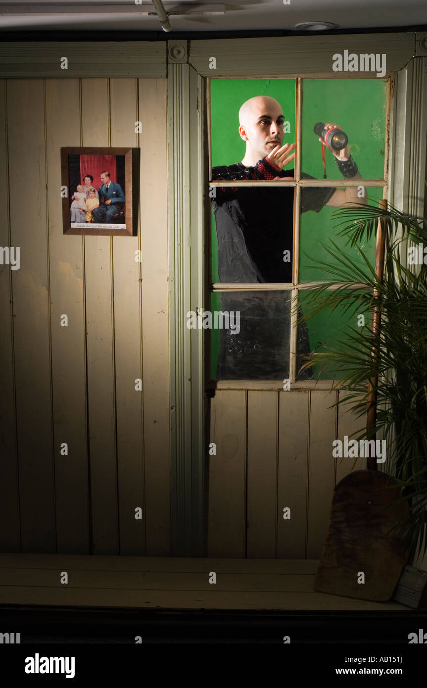 Sinister character in window, illuminated by harsh lighting Stock Photo ...