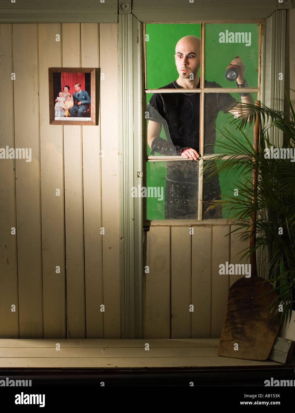 Sinister character in window, illuminated by harsh lighting Stock Photo ...