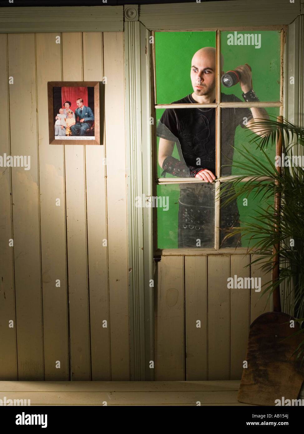 Sinister character in window, illuminated by harsh lighting Stock Photo ...