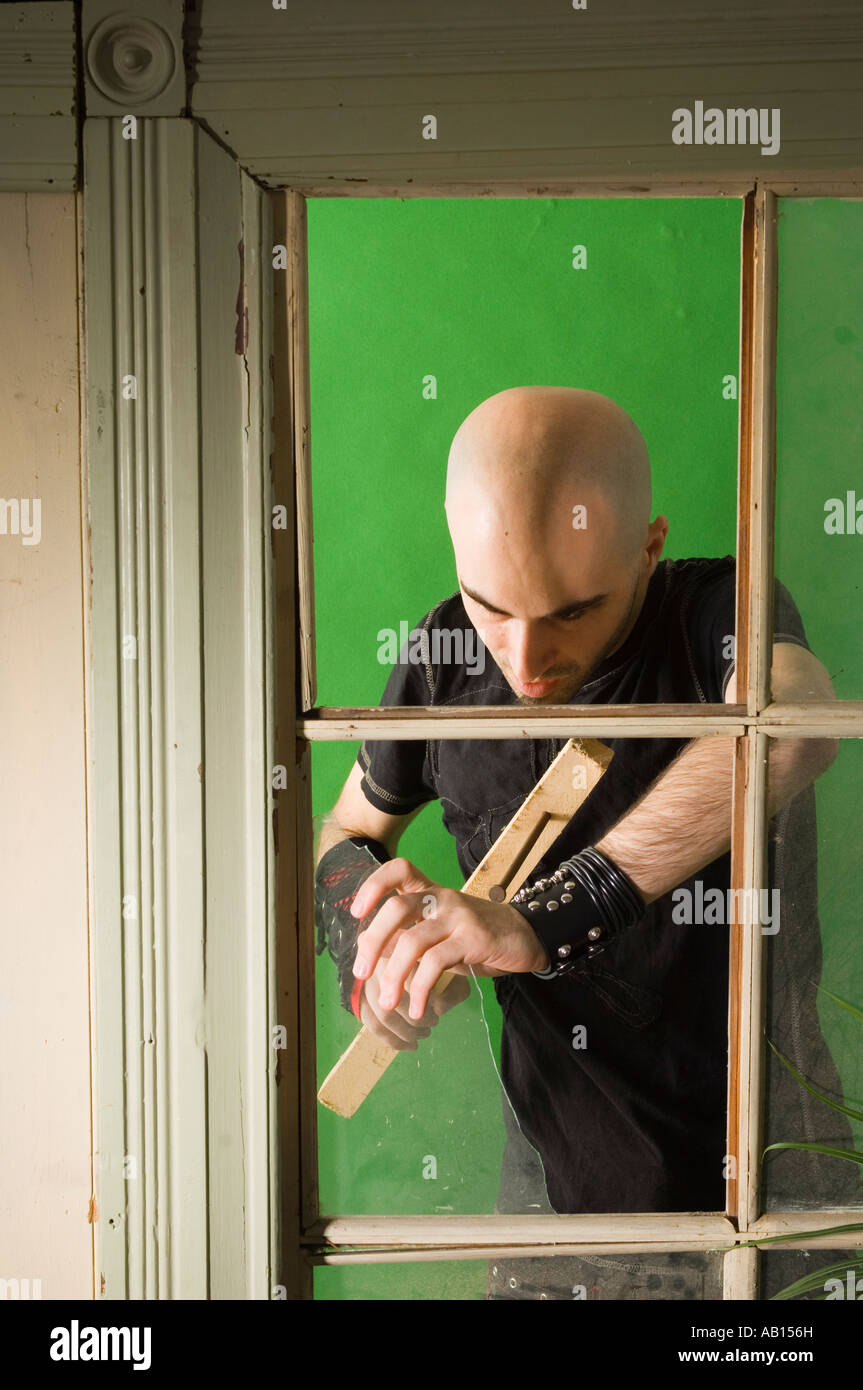 Sinister character in window, illuminated by harsh lighting Stock Photo ...