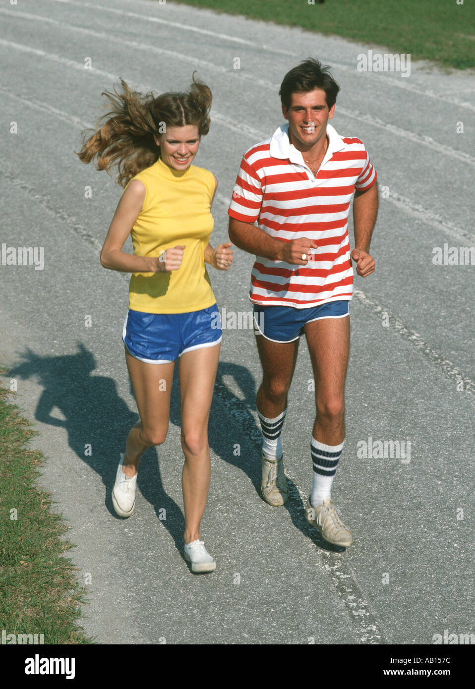 healthy young couple jogging on track Stock Photo - Alamy