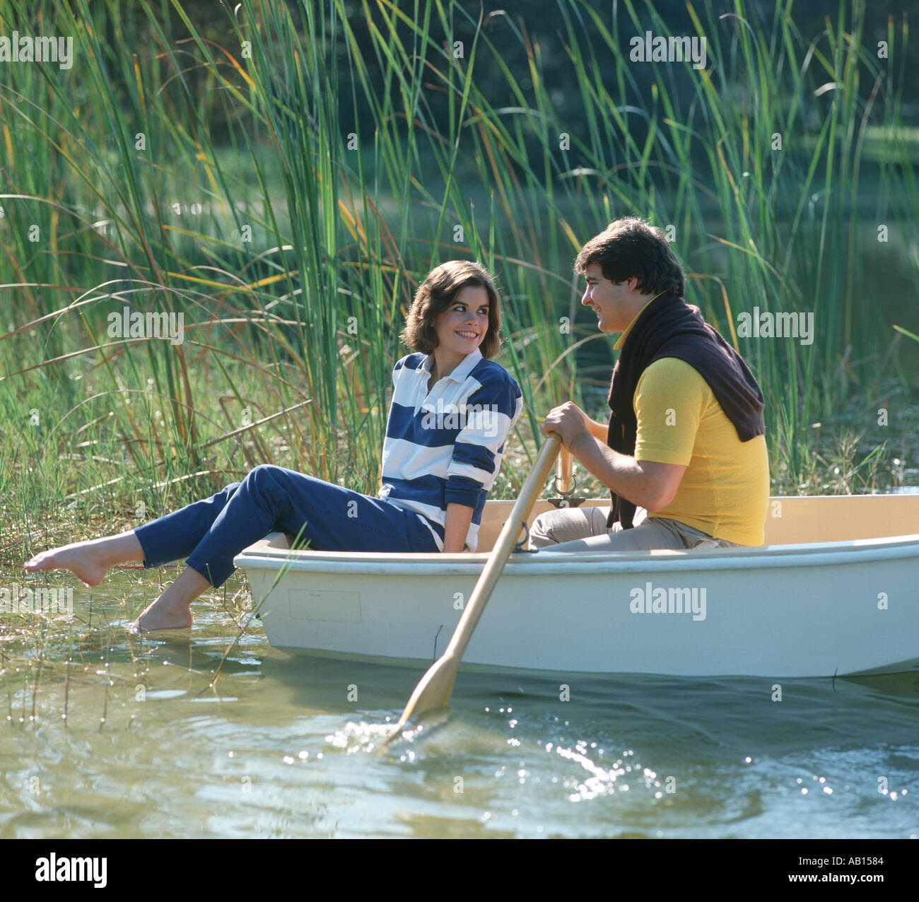 romantic couple enjoying a rowboat ride Stock Photo - Alamy