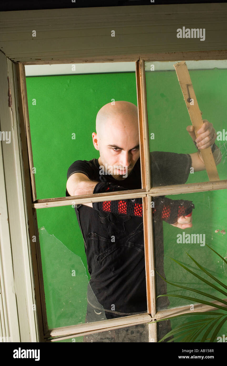Sinister character in window, illuminated by harsh lighting Stock Photo ...