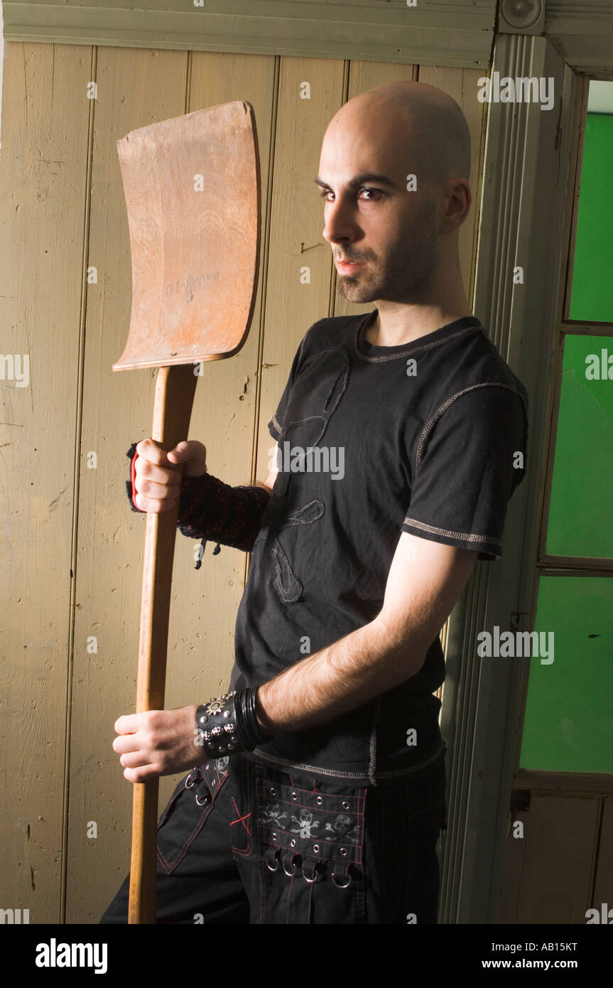 Sinister character with shovel, illuminated by harsh lighting Stock ...
