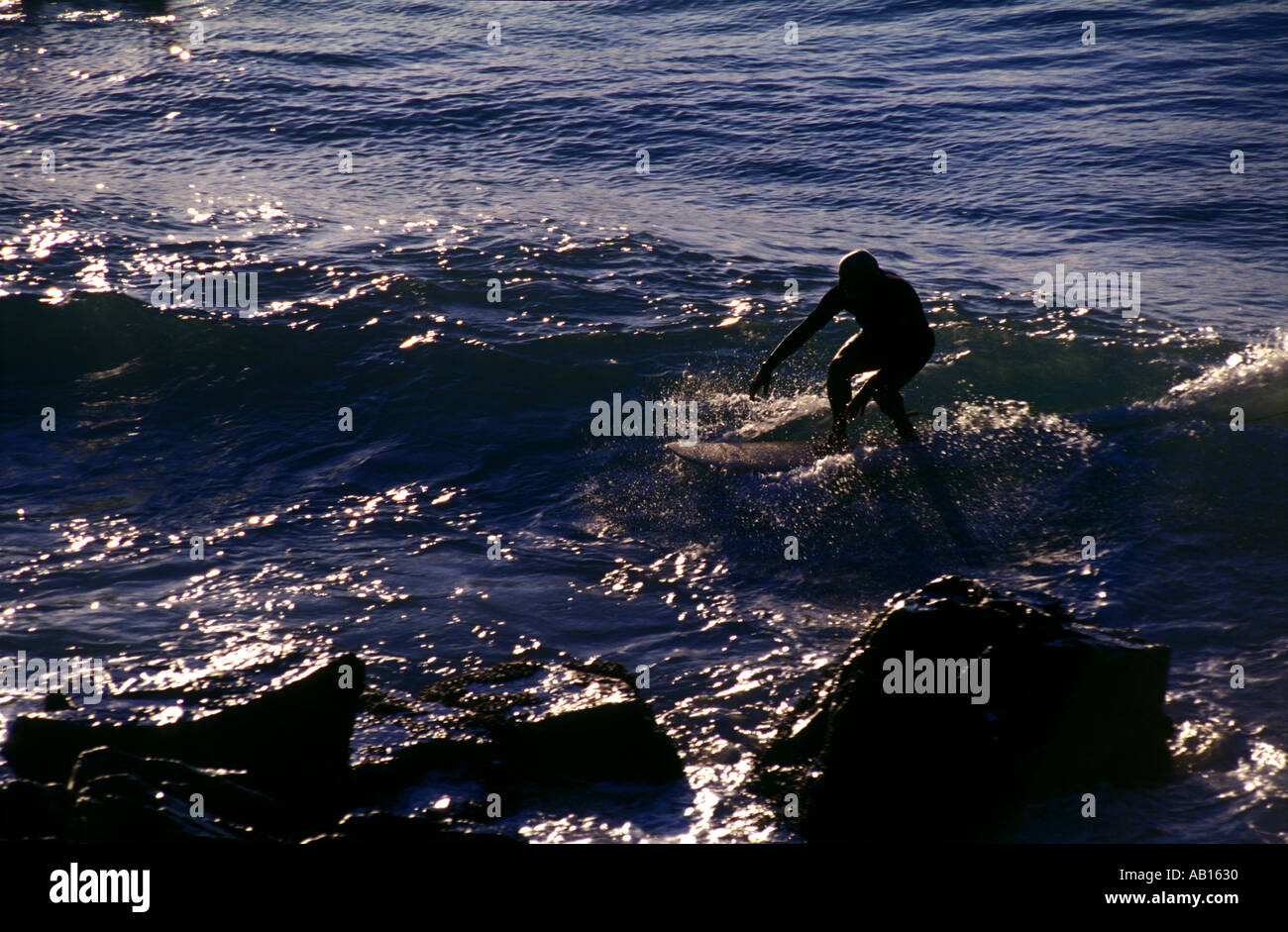 Surfing Near Rocks at Ida Wheeler blog