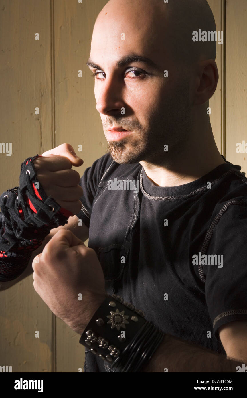 Sinister character illuminated by harsh lighting. Fighting stance Stock ...