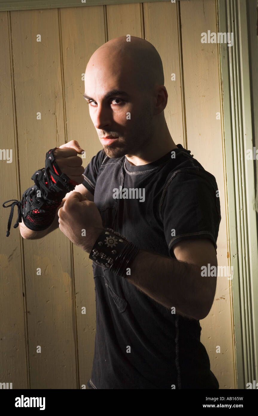 Sinister character illuminated by harsh lighting. Fighting stance Stock ...