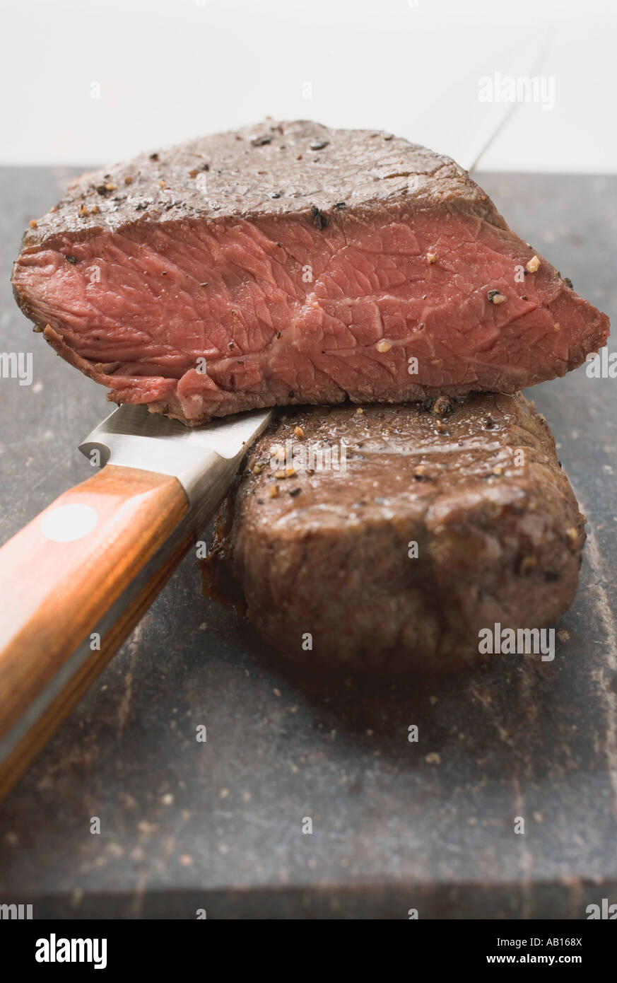 Beef steaks one with a piece cut off with knife FoodCollection Stock ...