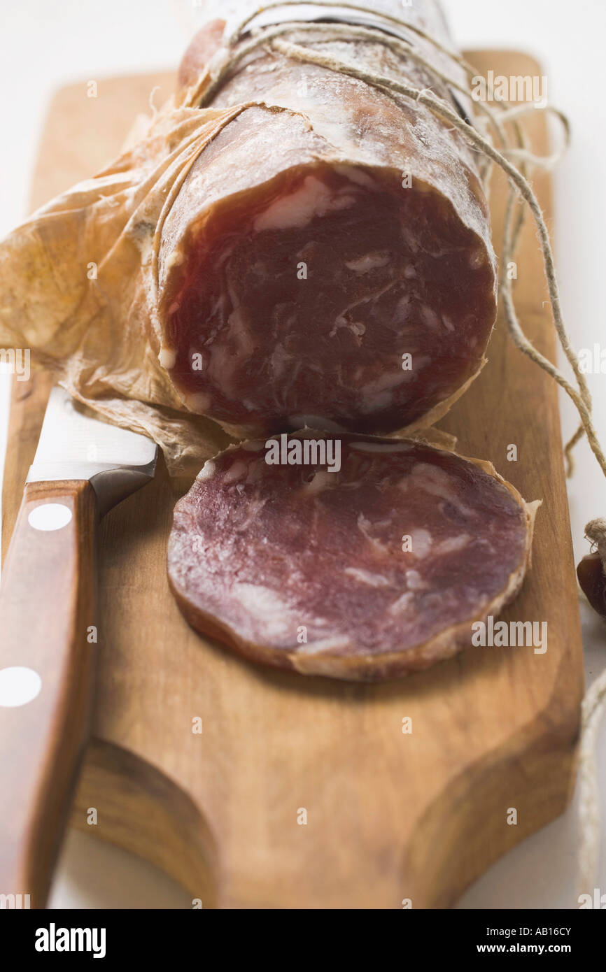Italian salami a slice cut on chopping board FoodCollection Stock Photo ...