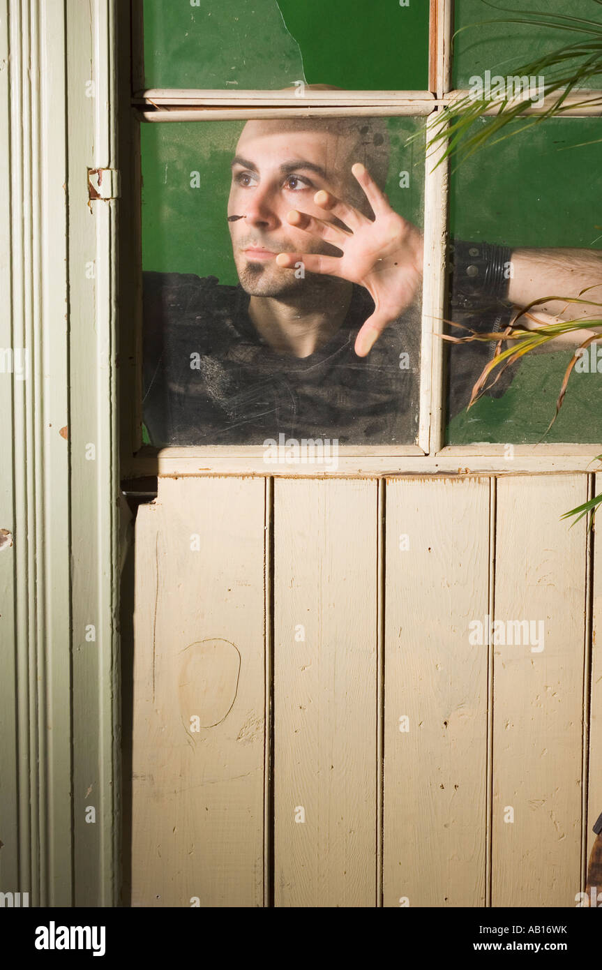 Man peering through glass hi-res stock photography and images - Alamy