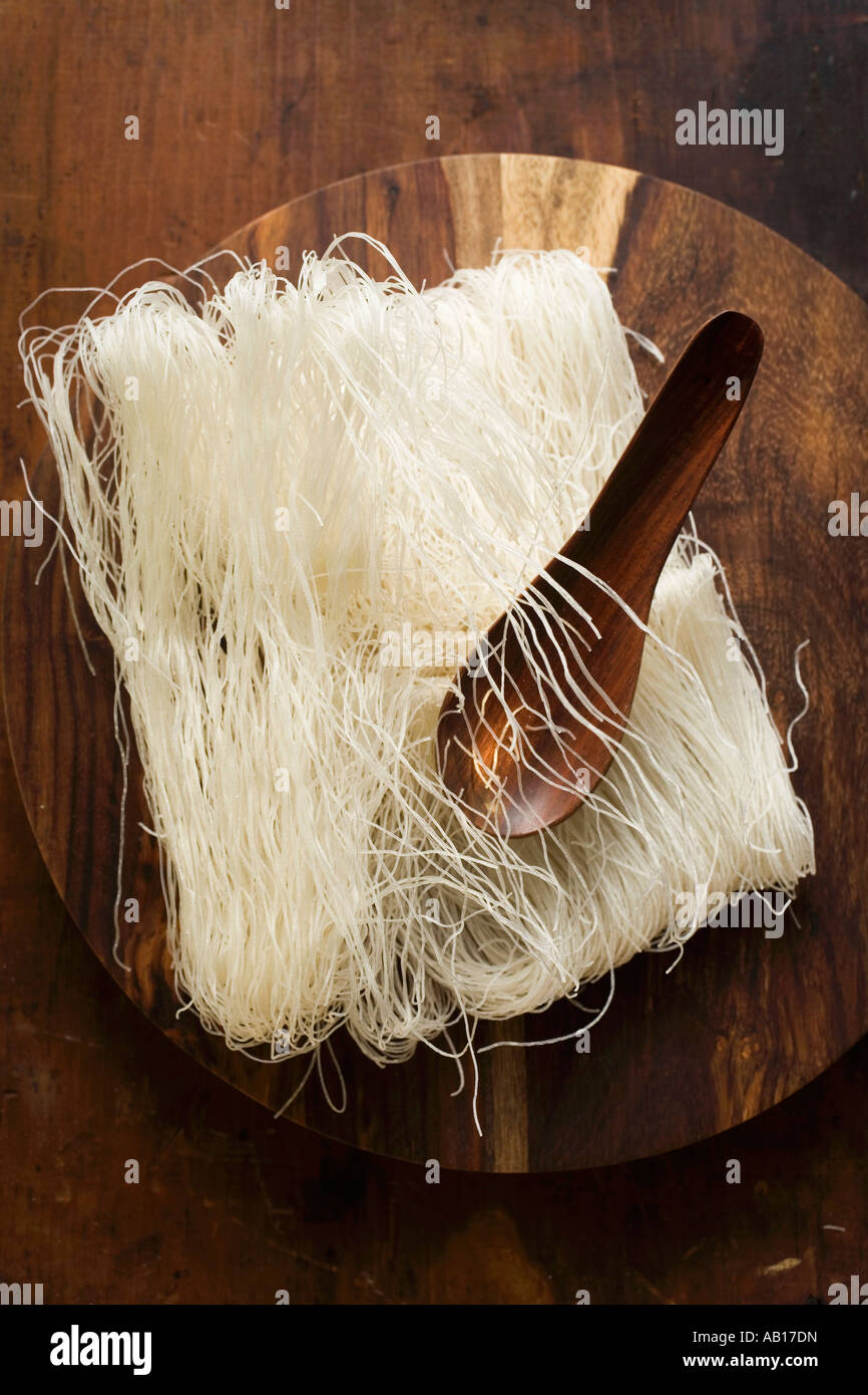 Thin rice noodles on wooden plate with spoon FoodCollection Stock Photo ...