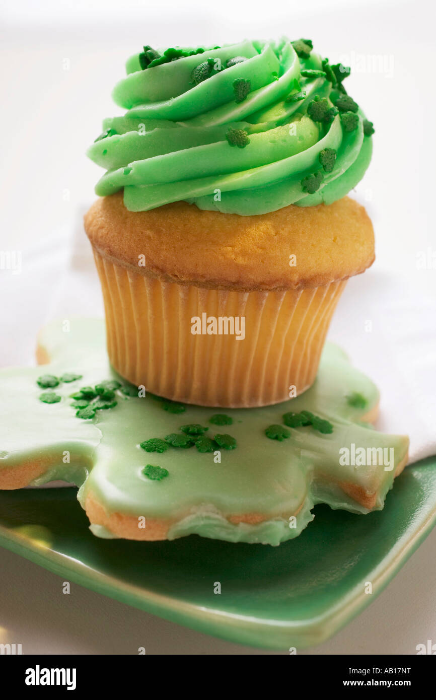 Muffin with green cream shamrock biscuit for St Patricks Day ...