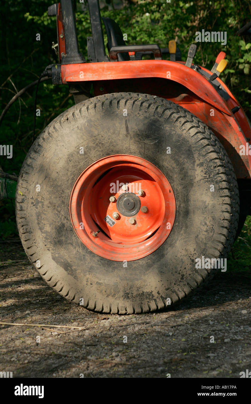 A single large red tractor wheel Stock Photo - Alamy