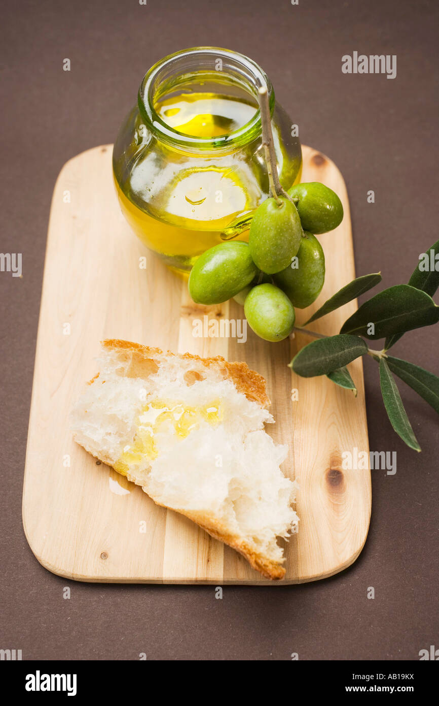 Olive sprig with green olives white bread and olive oil FoodCollection ...