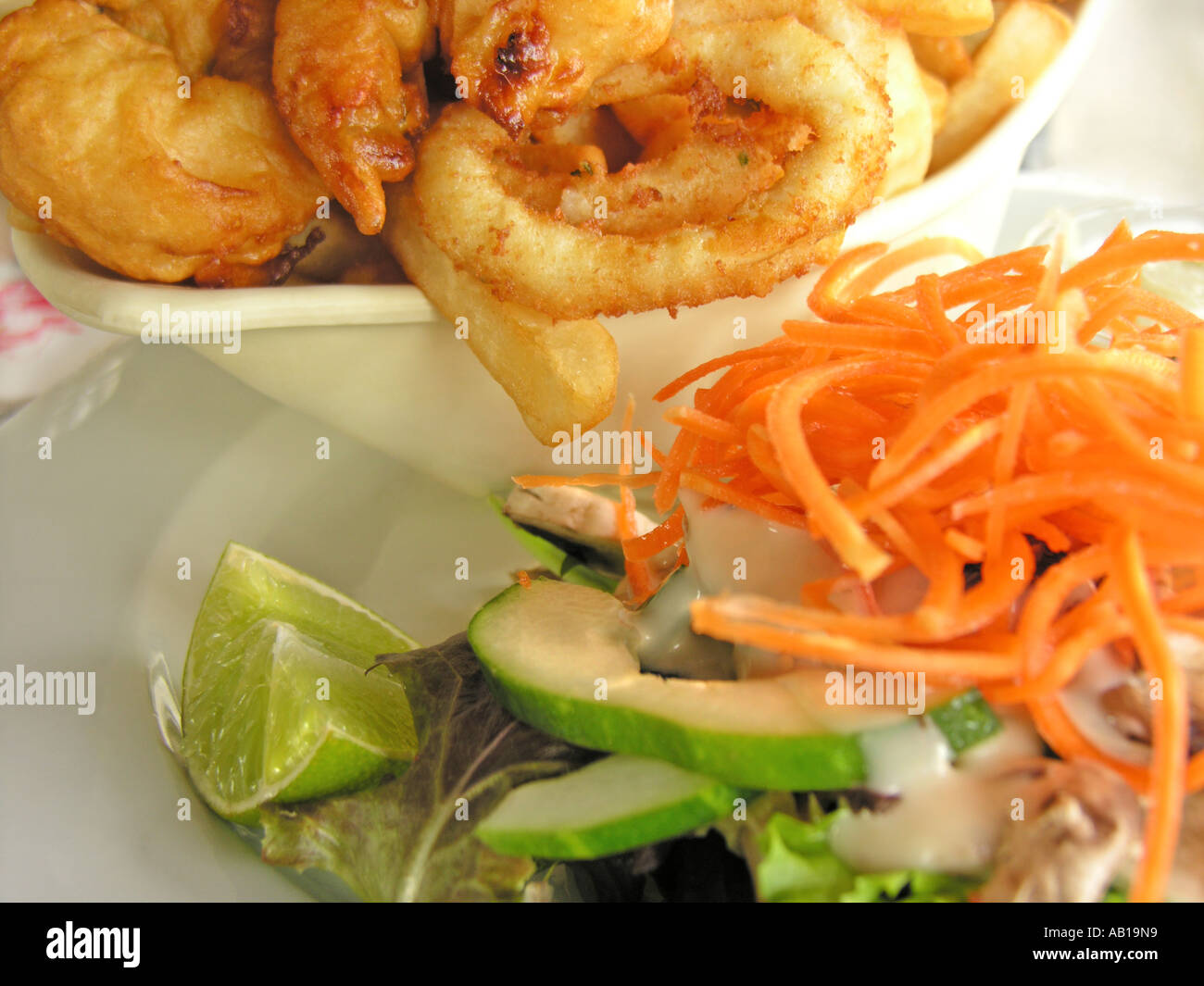 Fried calamari rings prawns fish and chips with salad Stock Photo - Alamy