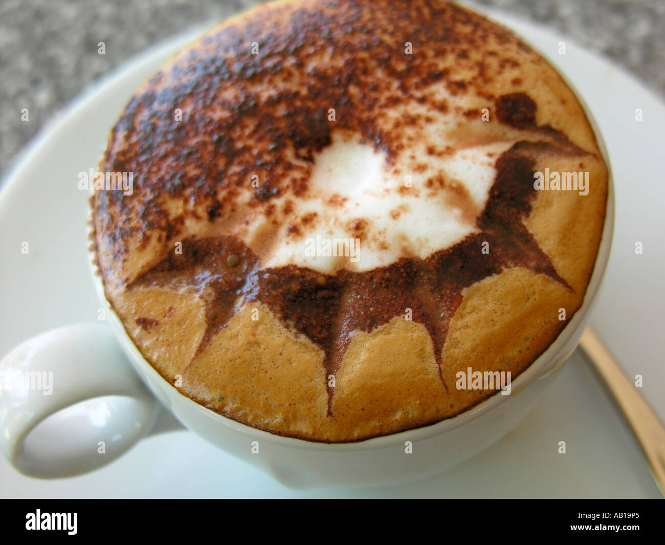 Cappuccino coffee with artistic chocolate pattern on froth Stock Photo ...