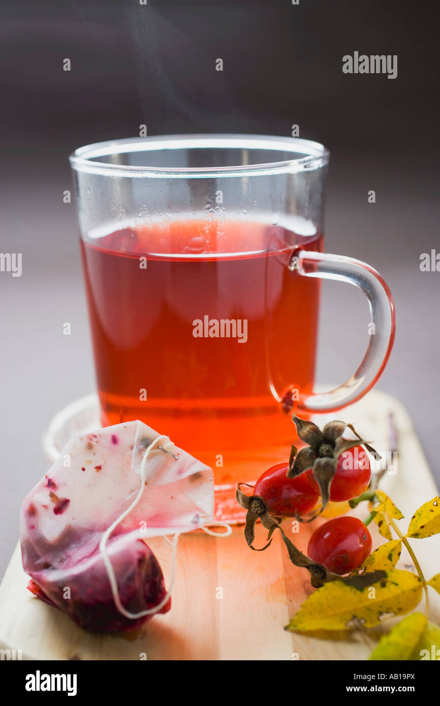 Rose hip tea in glass cup fresh rose hips and tea bag FoodCollection ...
