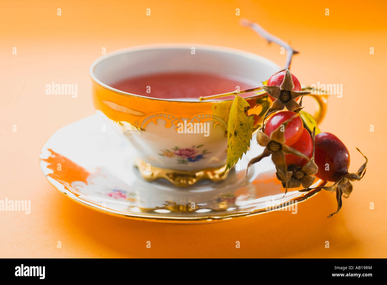 Rose hip tea in china cup fresh rose hips in saucer FoodCollection ...