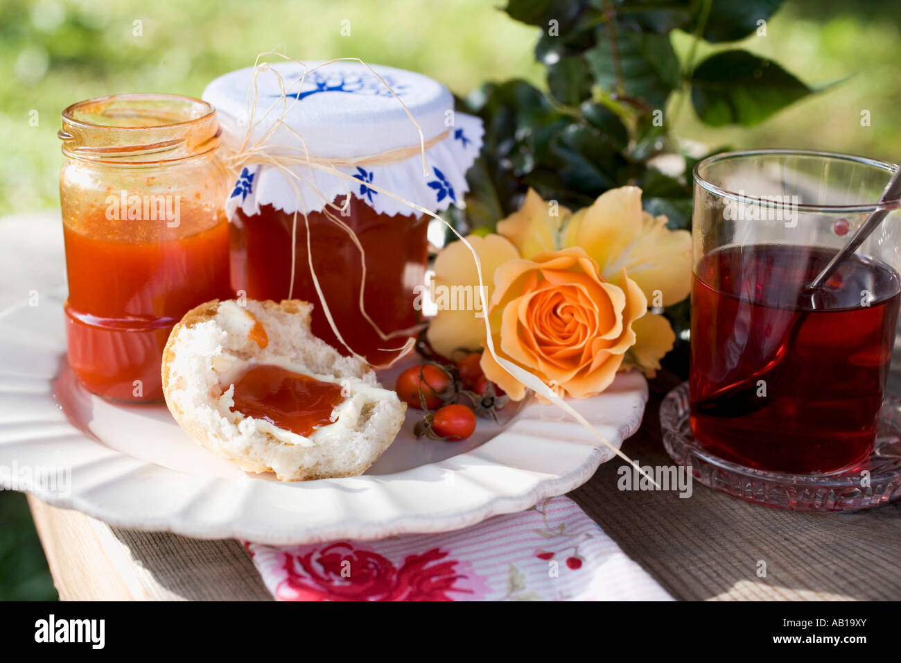 Rose hip jam in jars and on bread roll FoodCollection Stock Photo - Alamy