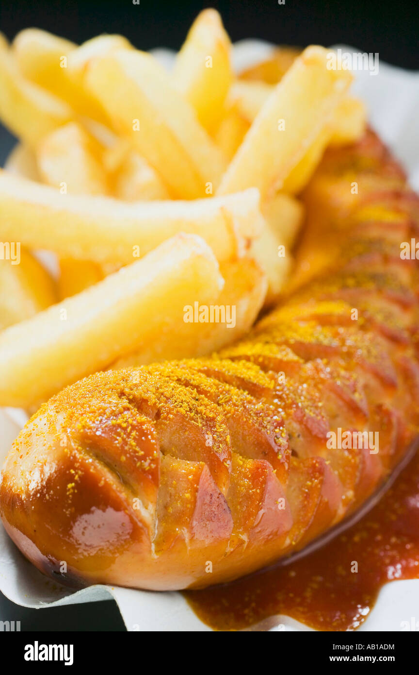 Currywurst sausage with ketchup curry powder chips close up ...