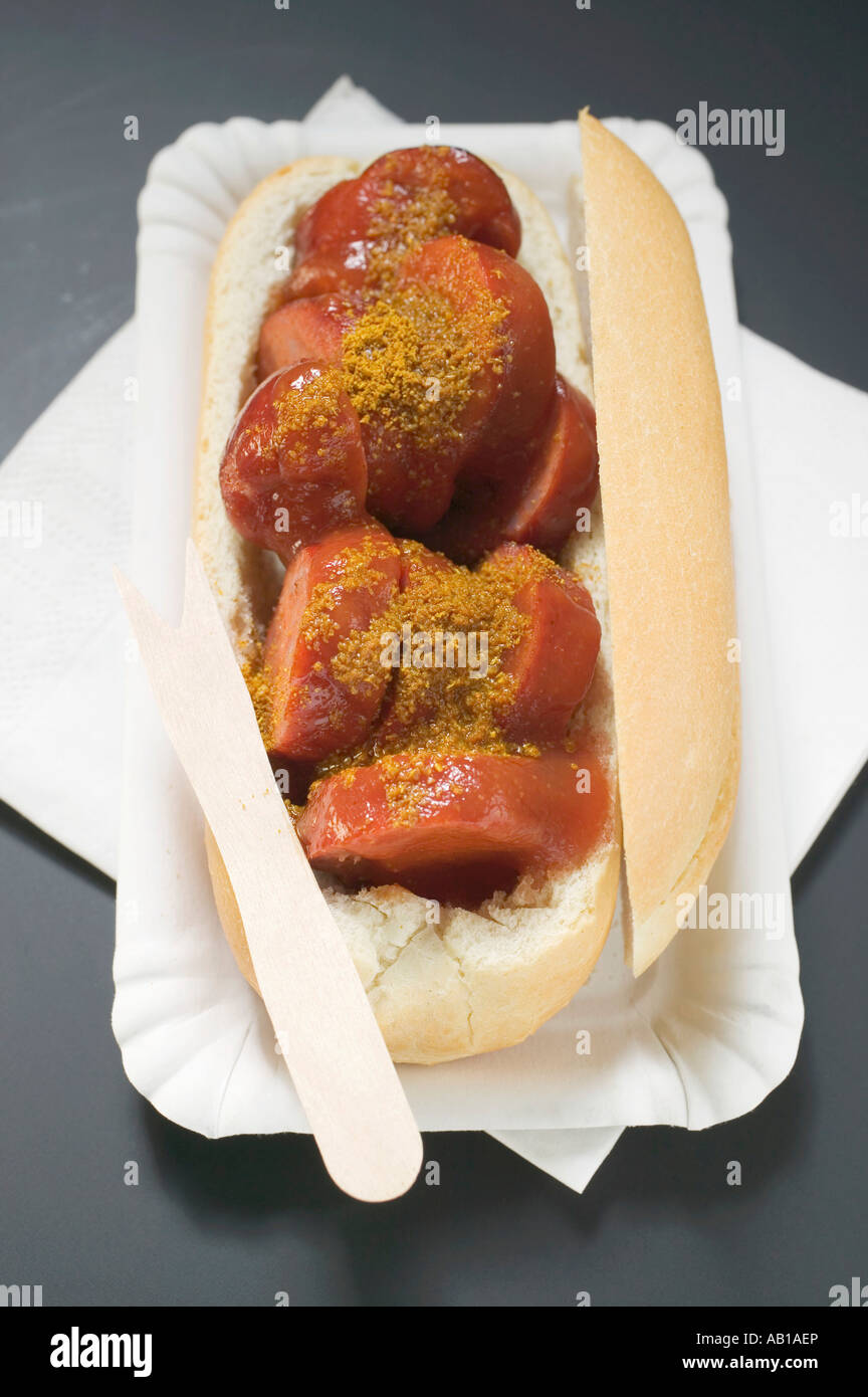 Currywurst sausage with ketchup curry powder in roll in paper dish ...